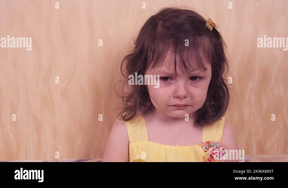 Emotions of a small child. Little girl in a yellow dress Stock Video ...