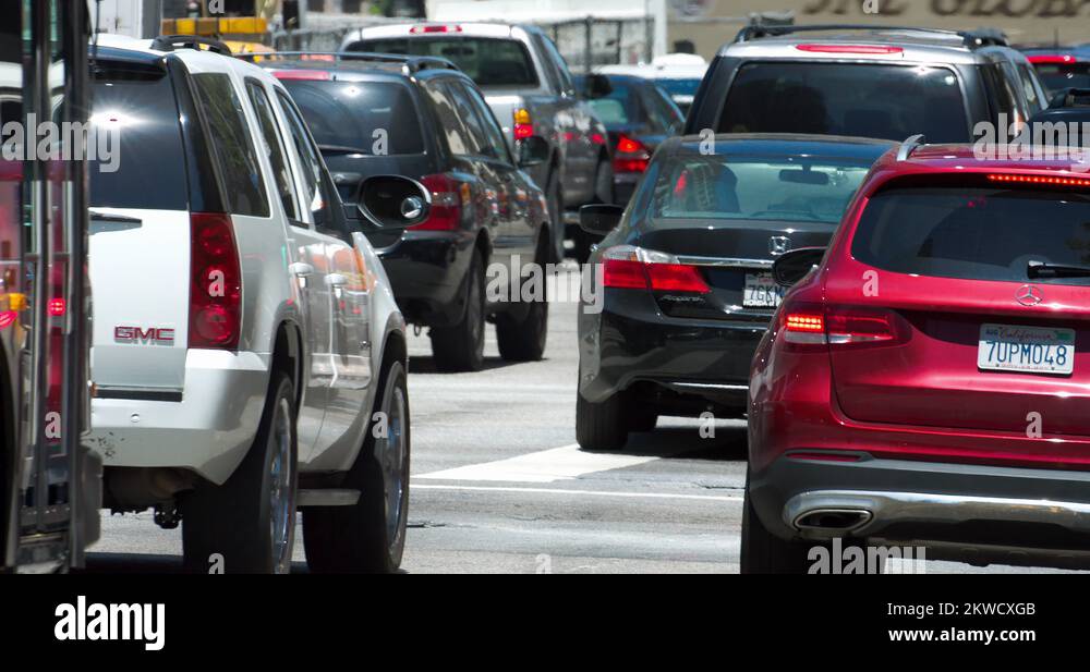 Traffic jam and people crossing intersection during rush hour in Los ...