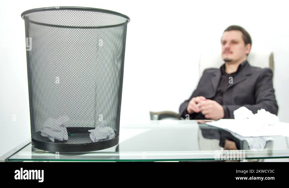 Throwing paper in the waste bin and a man is successful four times in a ...