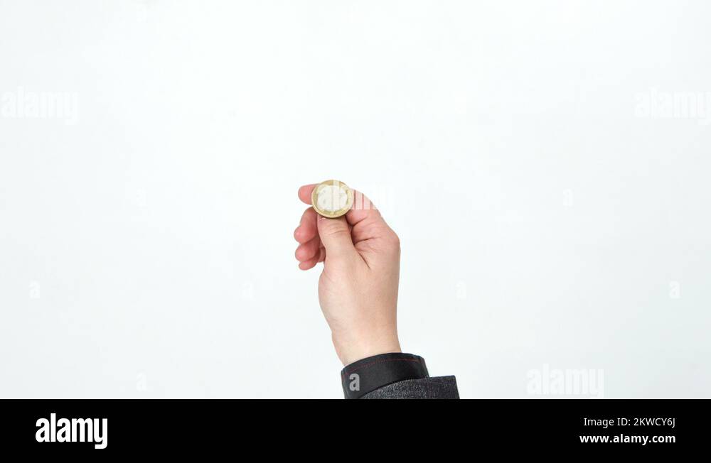 Throwing a 2-euro coin up in the air and catching it on his palm Stock ...