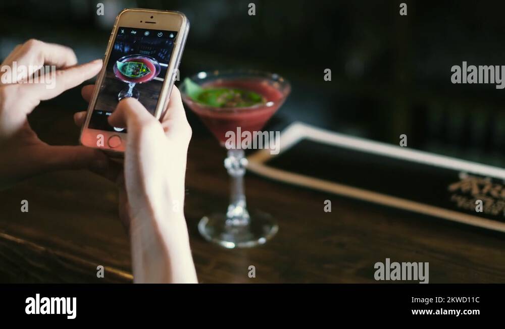 Beautiful woman taking pictures of a cocktail at the bar 4k Stock Video ...