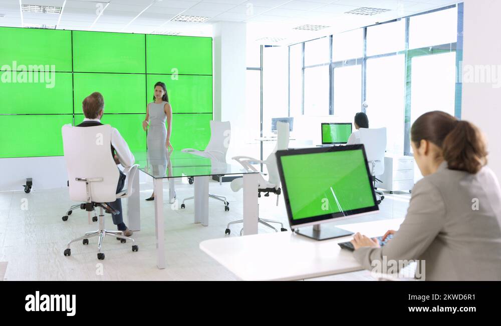 4K Business team in modern office green screen on video wall & computer ...