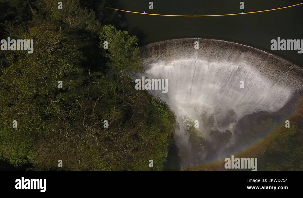 4K aerial of dam overflowing with water from rain storm flooding Stock ...