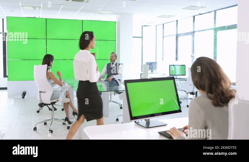 4K Business team in modern office green screen on video wall & computer ...