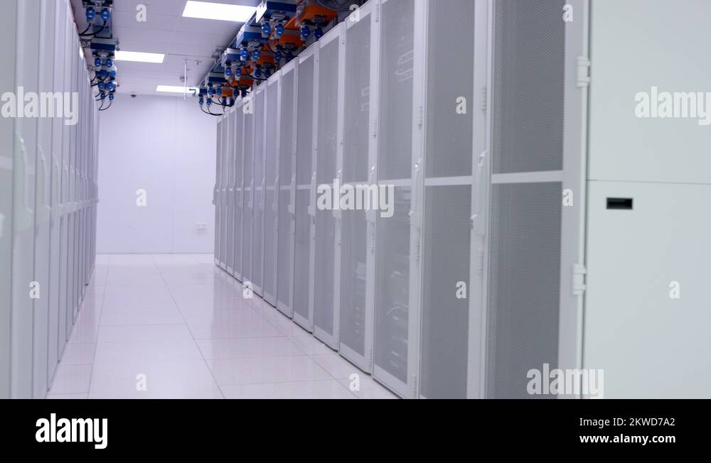 4K Empty interior of large modern data centre with rows of server racks ...