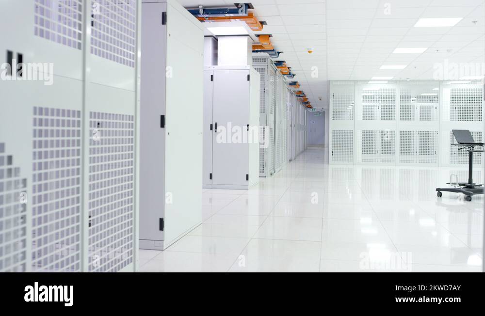 4K Empty interior of large modern data centre with rows of server racks ...