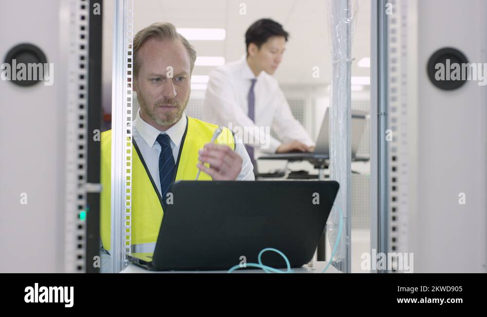 4K Technical engineers carrying out checks in a data center server room ...