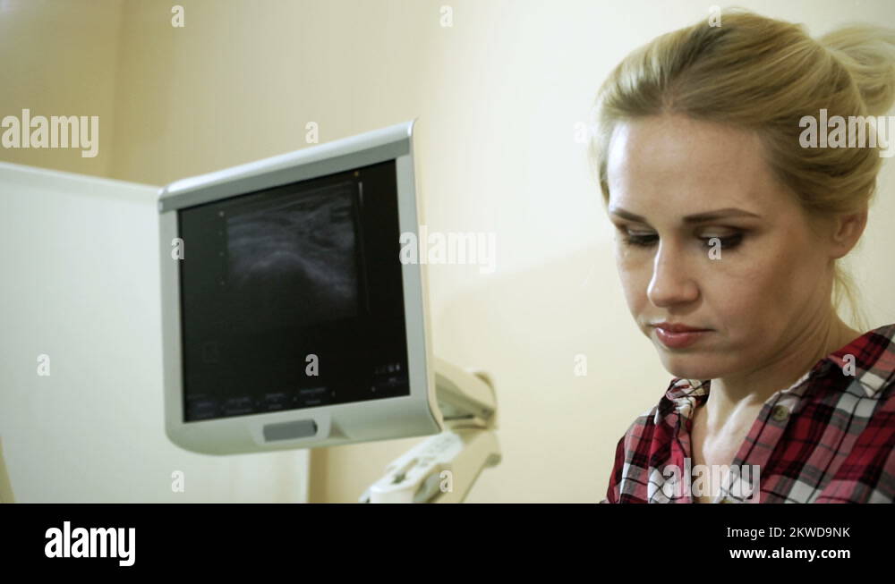Ultrasonic scanning. The woman is on an ultrasound examination in a ...