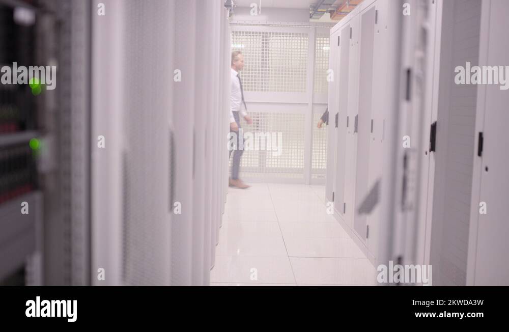 4K View through mesh door of a data cabinet in a data center with staff ...