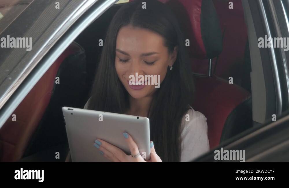 young beautiful brunette girl travelling on the business class car ...