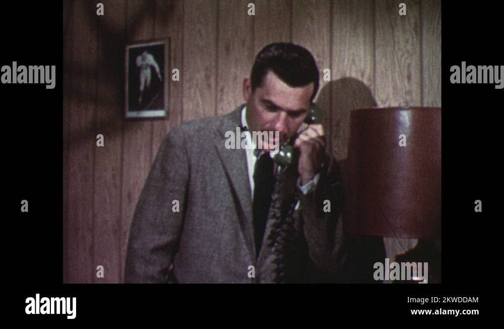 1950s: Man answers telephone and smiles. Man talks on phone. Man puts ...