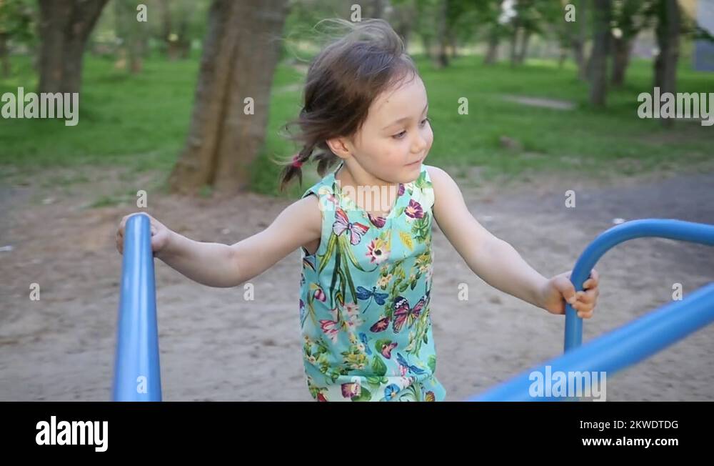 Active little child girl play on park playground running with a ...
