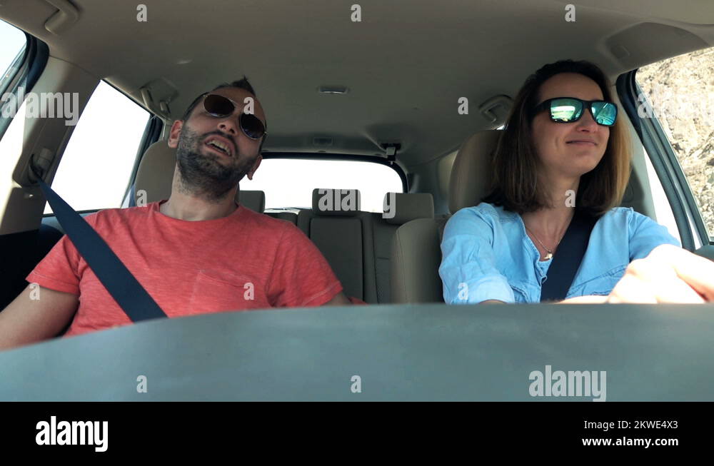Happy Young Couple Singing In Car Woman Driving Super Slow Motion