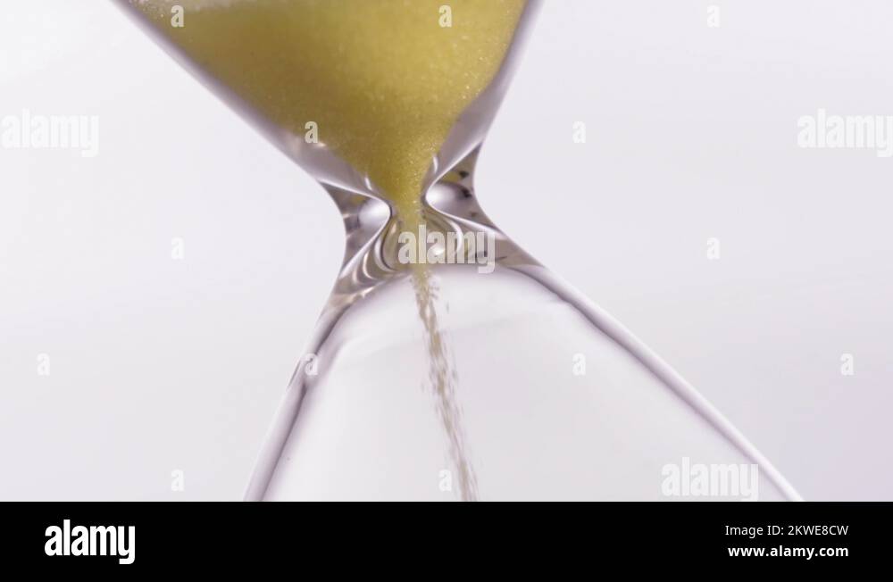 Hourglass, Hourglass. Sand passing through the neck of an hourglass ...