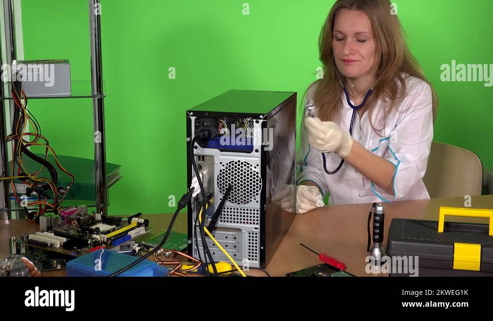 Pretty woman in white robe diagnosing computer problems with ...