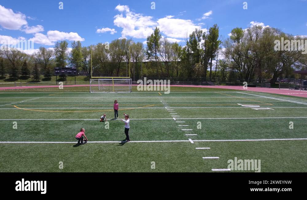 Little kids playing football on the field Stock Video Footage - Alamy