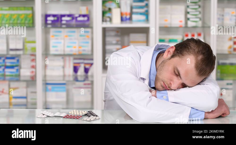 Overworked Pharmacist Man Sleeping on Desk Tired After Busy Day ...