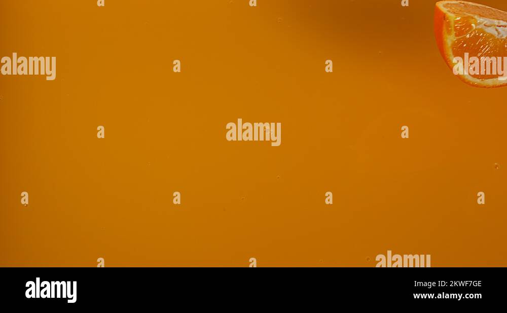 Orange, citrus sinensis, Fruit falling into Orange Juice, Slow Motion ...