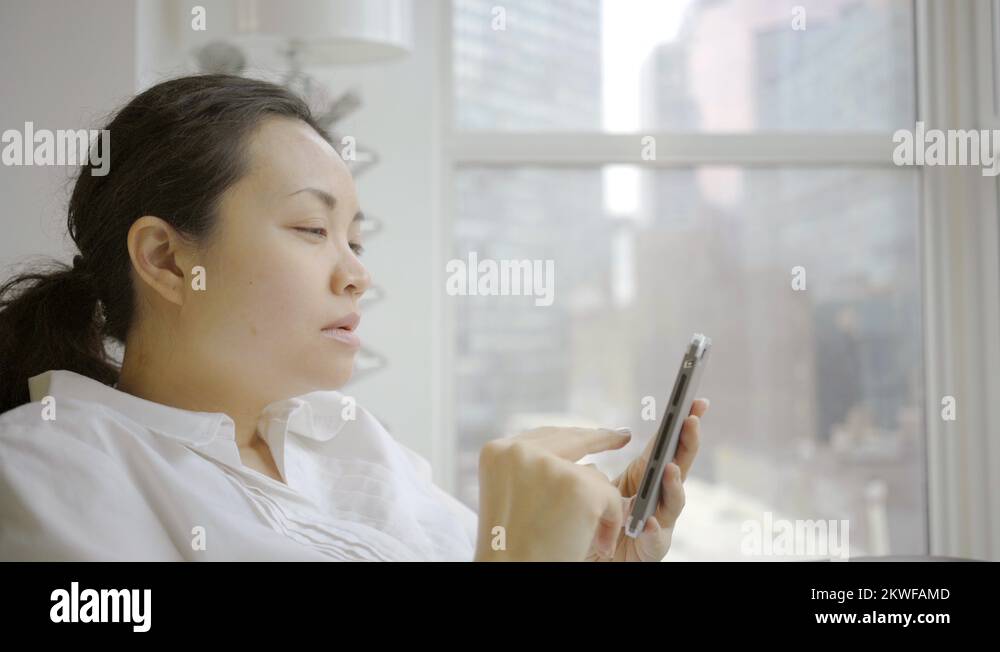 Woman in her 30s inside a modern condominium in downtown toronto ...