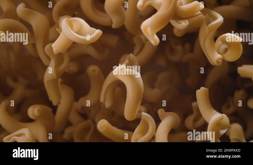Raw cellentani pasta flies after being exploded. Slow Motion Stock ...