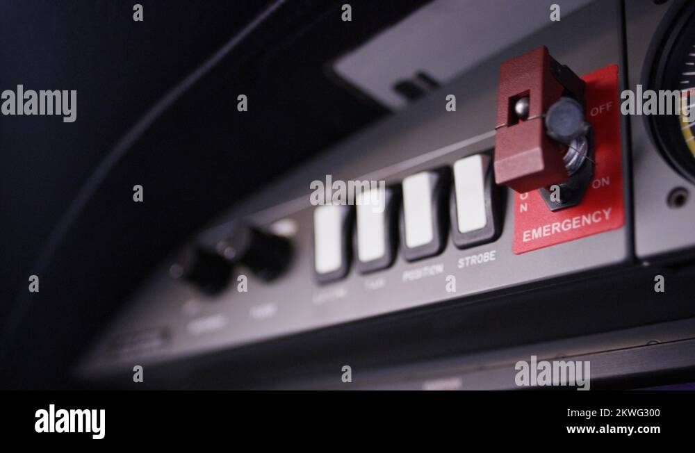 Plane control panel. Switches on plane cockpit. Red emergency button in ...