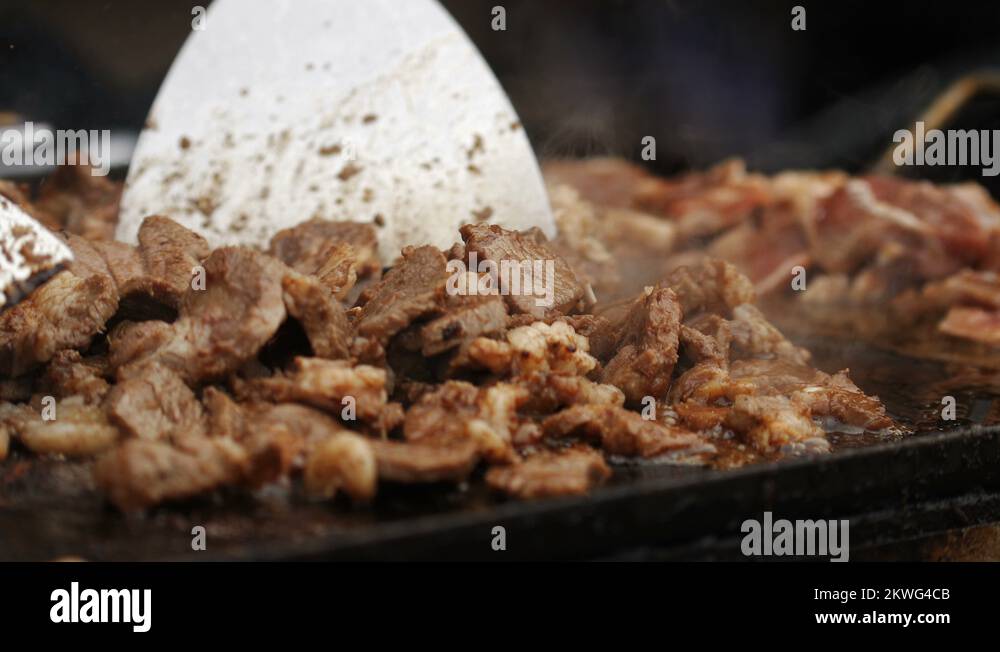 Man preparing lamb meat for his menu in his stall at Ramadhan bazaar ...