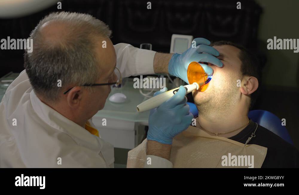Close-Up,dentist Illuminates The Filling on The Tooth of the Patient ...