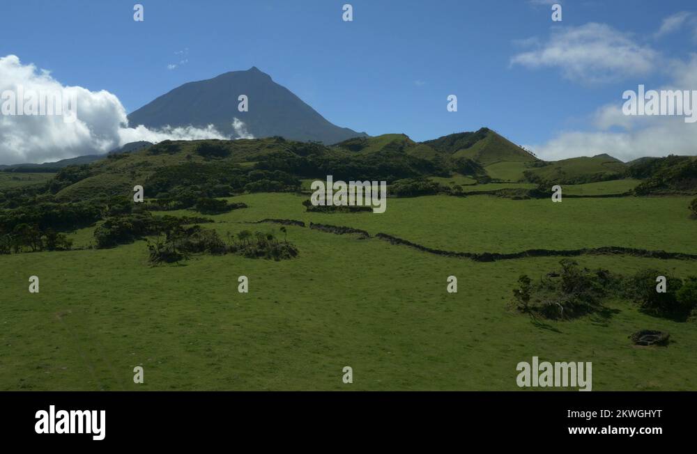 Pico Azores aerial with green hills and pico mountain, sideways move 4K ...