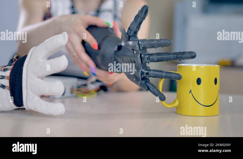 Yellow cup being lifted and put down by bionic arm. 4K Stock Video ...