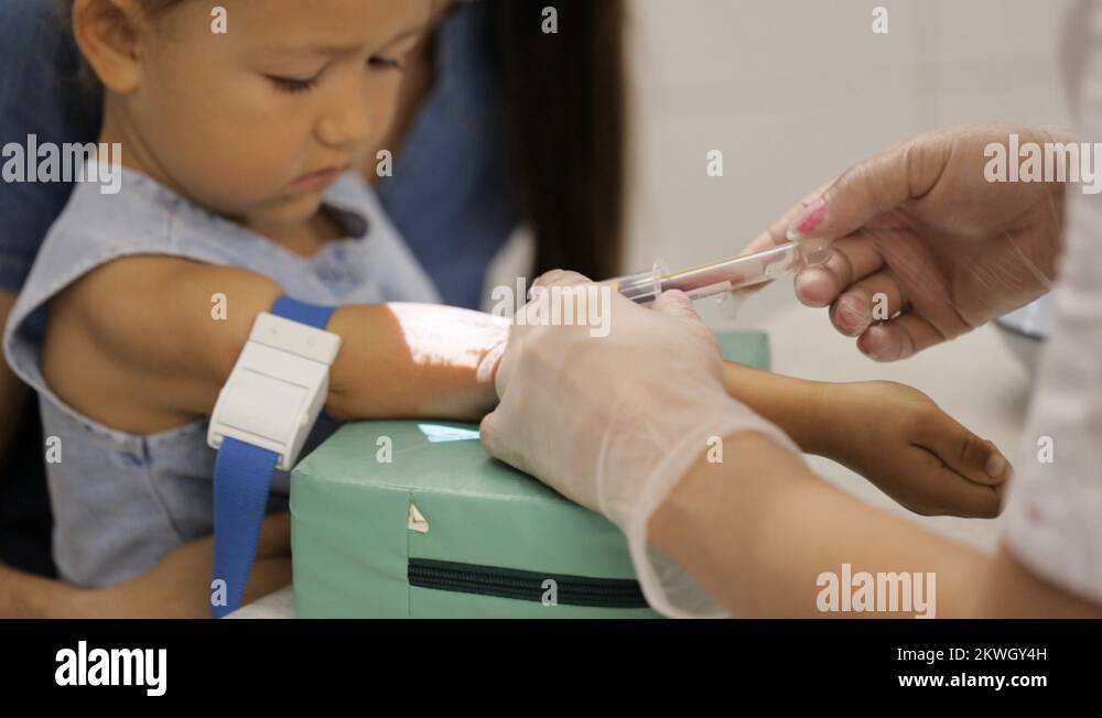 Little girl with mother in hospital. Nurse taking girl's venous blood ...