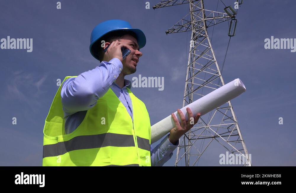 Electrician foreman talking to power distribution clients by pillar ...