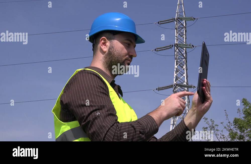 Checking energy distribution electrician male sliding tablet ...
