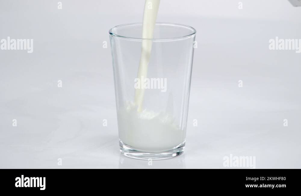 Pouring some fresh milk into an empty glass Stock Video Footage - Alamy