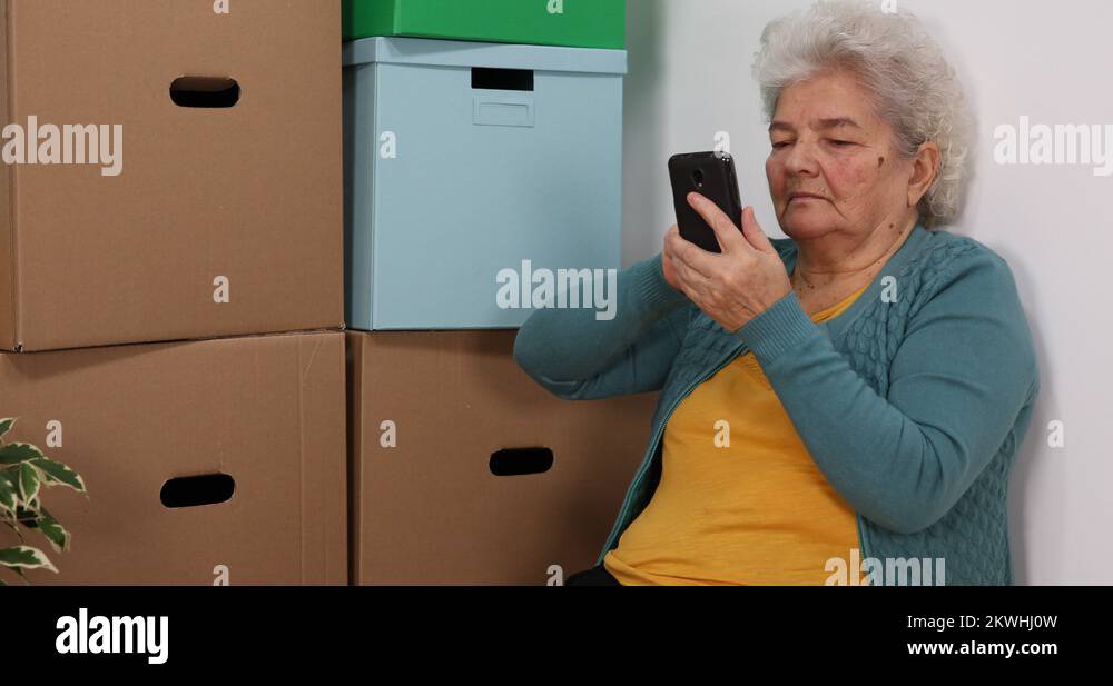 Retired Grandma Searching in Nephew Mobile Phone Message in Home ...