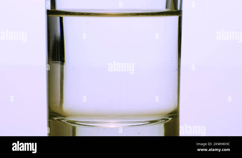 Taking medicine. Two effervescent tablets dissolving in a glass of ...