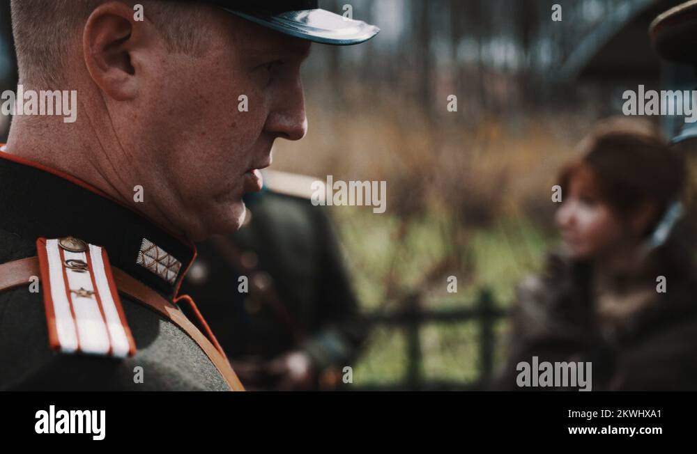 Red haired girl in group of men in retro soviet officer uniforms Stock ...