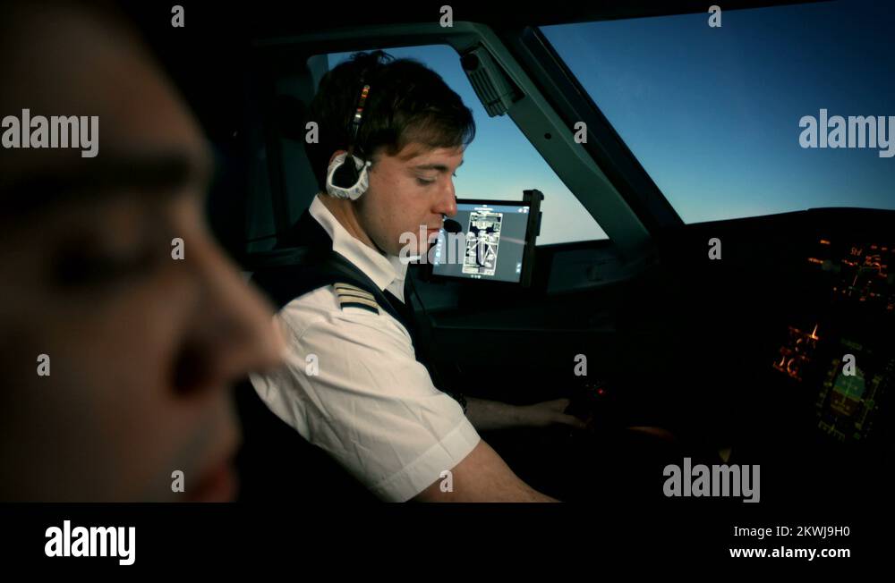 Captain and copilot in the flight deck of a passenger aircraft during ...
