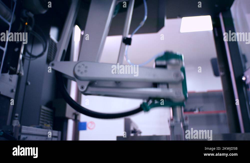 Robot arm at packaging line. Automated process. Industrial equipment ...