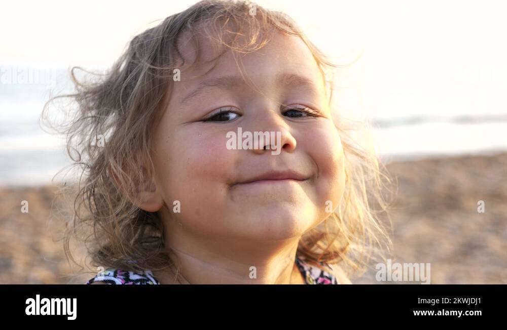 Close-up happy child face. Children in summer nature view at the beach ...