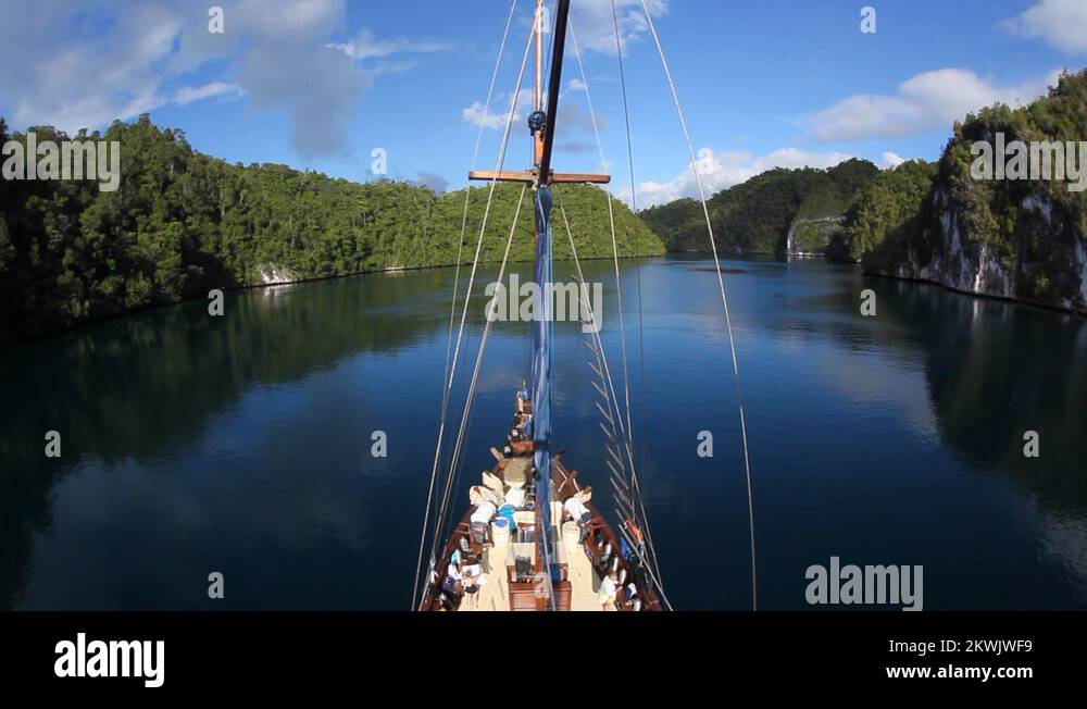 Schooner Sailing Between Islands in Raja Ampat Stock Video Footage - Alamy
