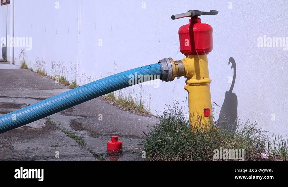 Water spraying from fire hydrant hose bright summer day side view Stock ...