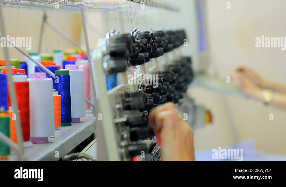 Close-up a employees of a textile factory works in the shop for sewing ...