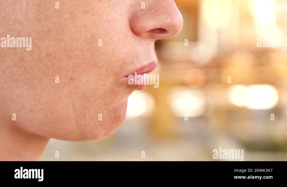 A woman chewing food from a close-up fork. profile. Slow motion Stock ...