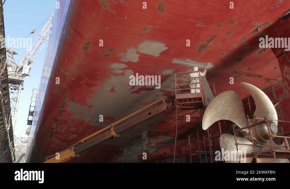 Ship Yard Worker Painting the hull of a huge ship Stock Video Footage ...