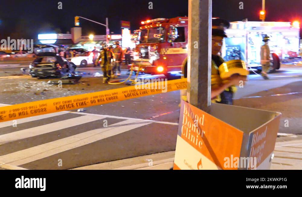 Police officer installing a do not cross line on the scene of a car ...