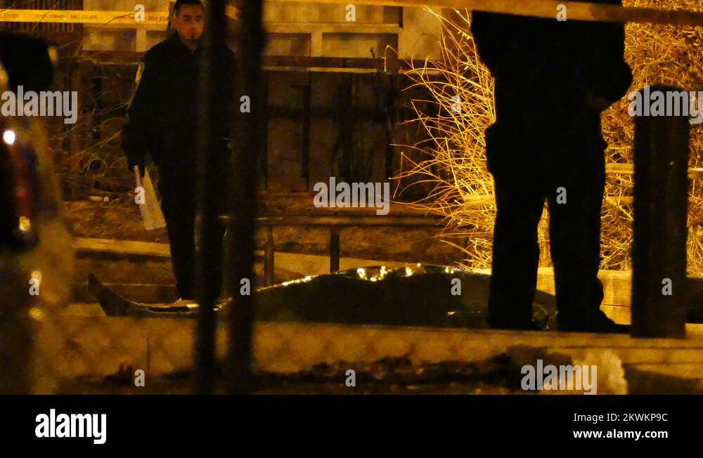 Police officers guarding a dead body under a tarp on the ground Stock ...