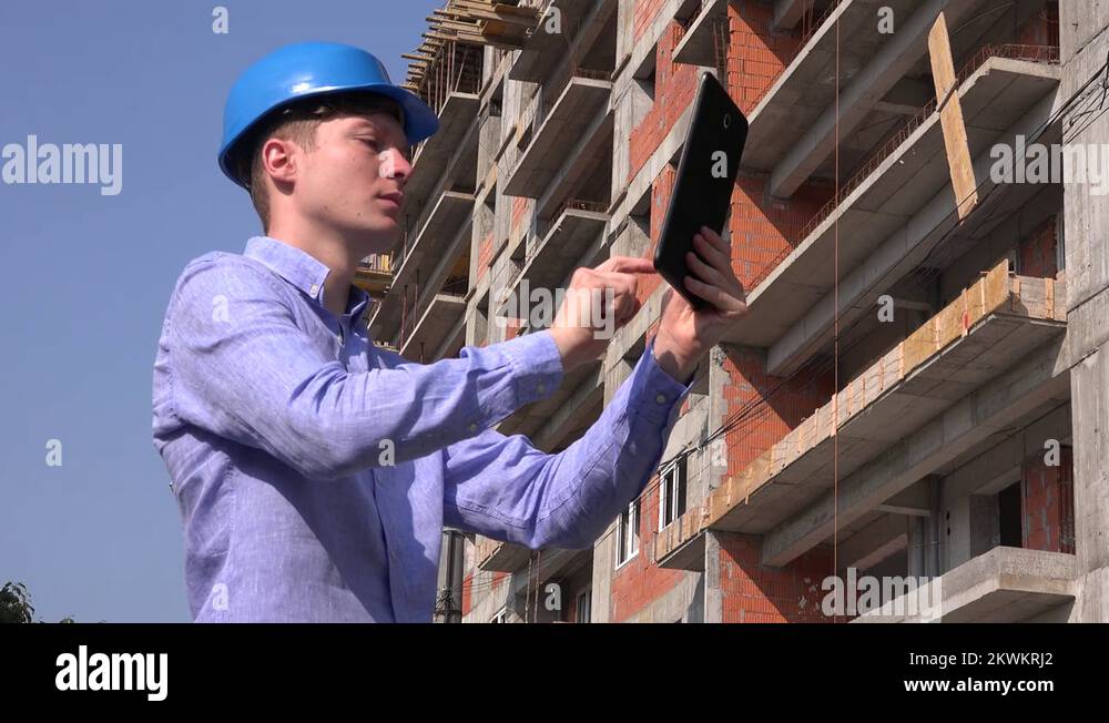 Architect supervisor taking tablet photos to house home building ...
