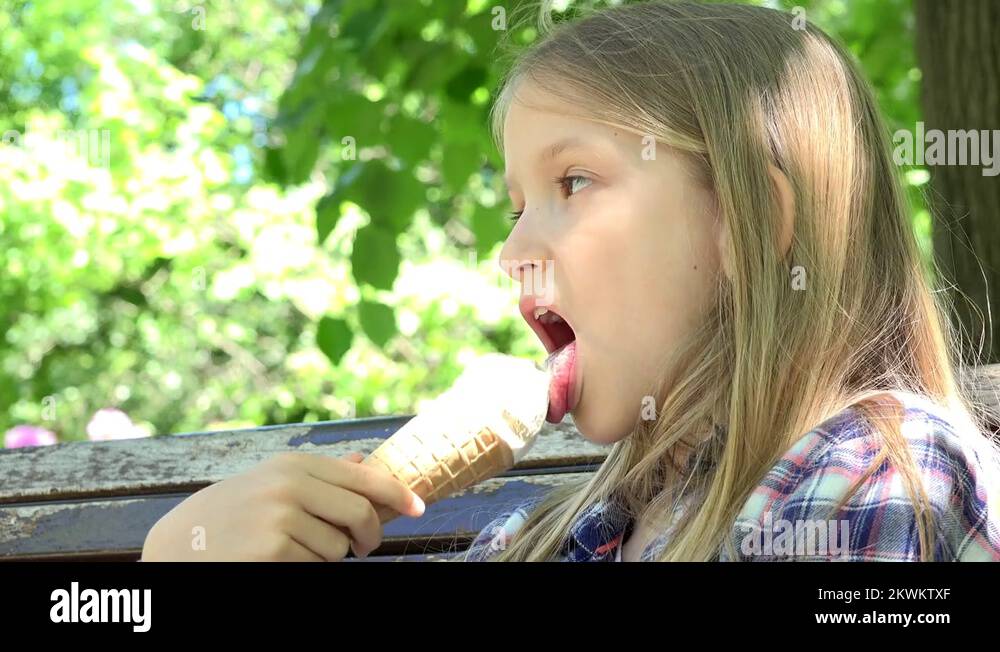 Child Eating Ice Cream at Playground, Girl Relaxing Sitting on Bench in ...