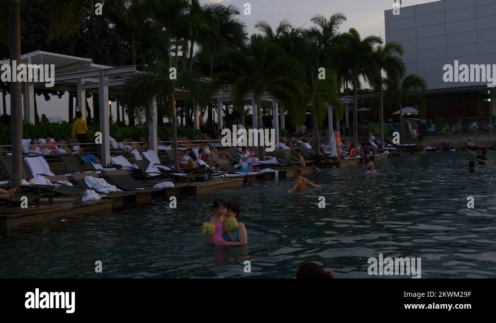 twilight crowded hotel rooftop swimming pool relaxed panorama 4k ...