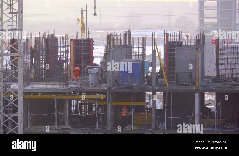 Builders on the top floor of the new building install formwork Stock ...